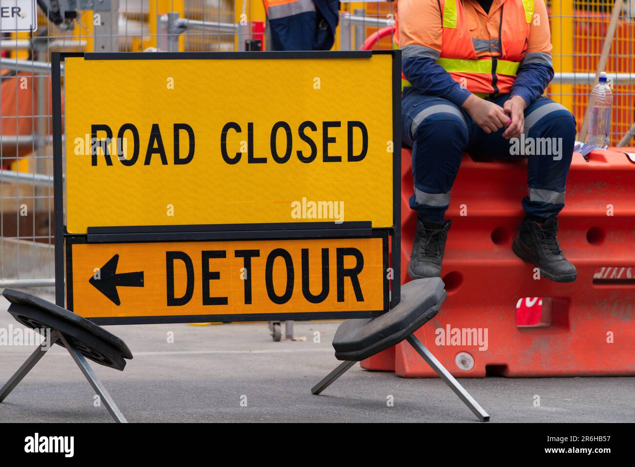 Metal yellow background road closed detour sign indicating construction ...
