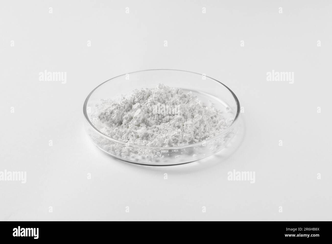 Petri dish with calcium carbonate powder on white background Stock ...
