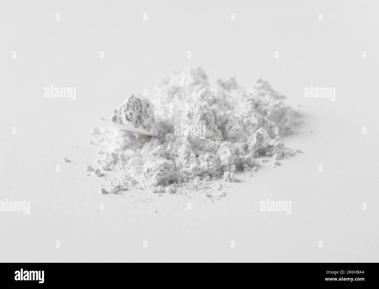 Heap of calcium carbonate powder on white background Stock Photo - Alamy