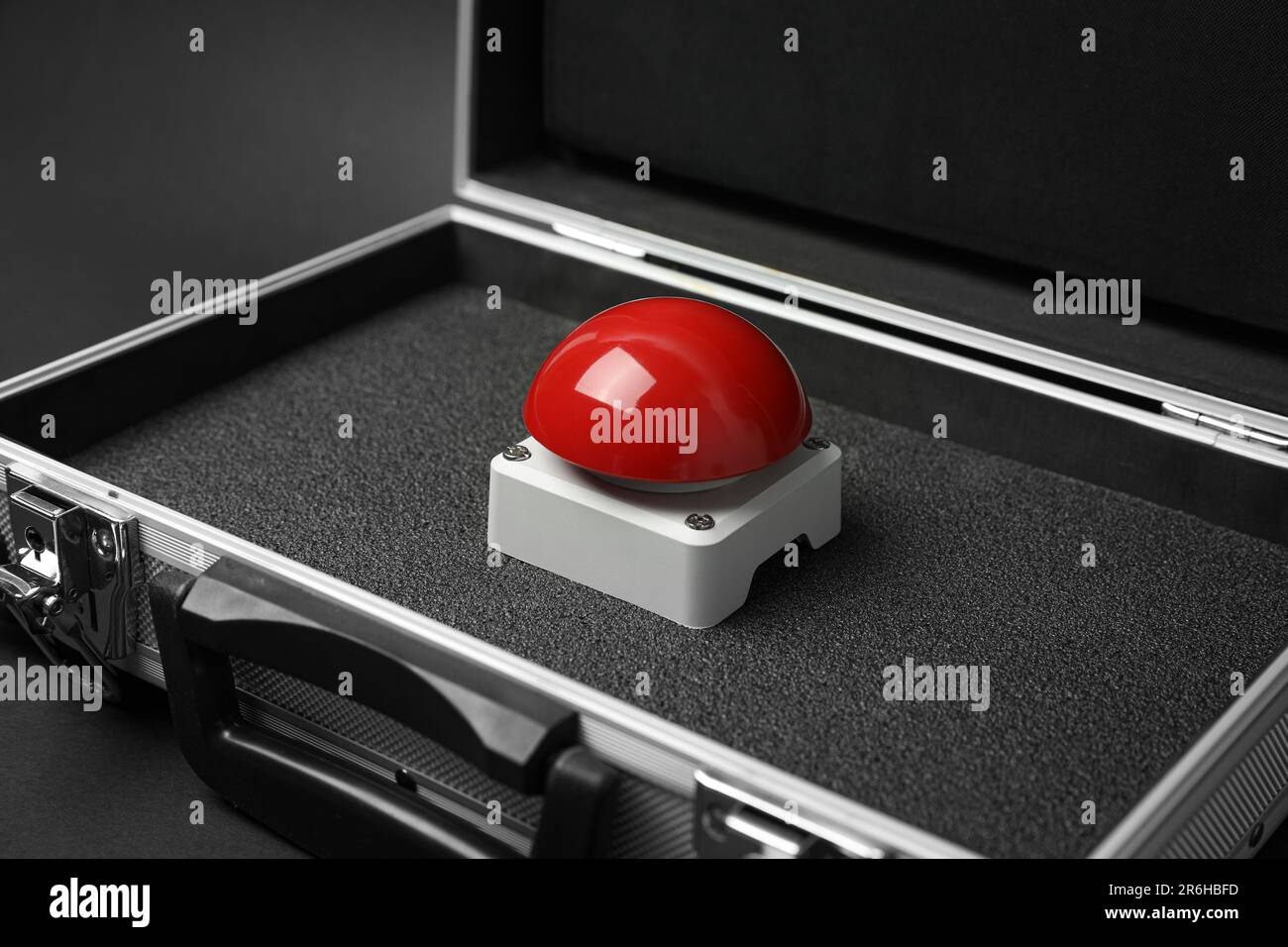 Red button of nuclear weapon in suitcase on black background. War ...