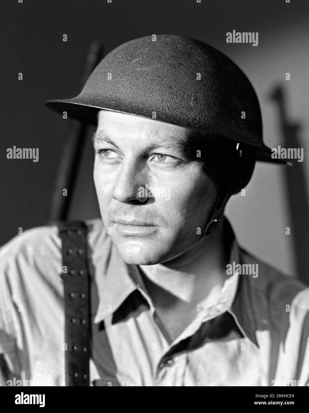 1940s UNITED STATES SOLDIER GRIM FACE WEARING A BRODIE HELMET AND ...