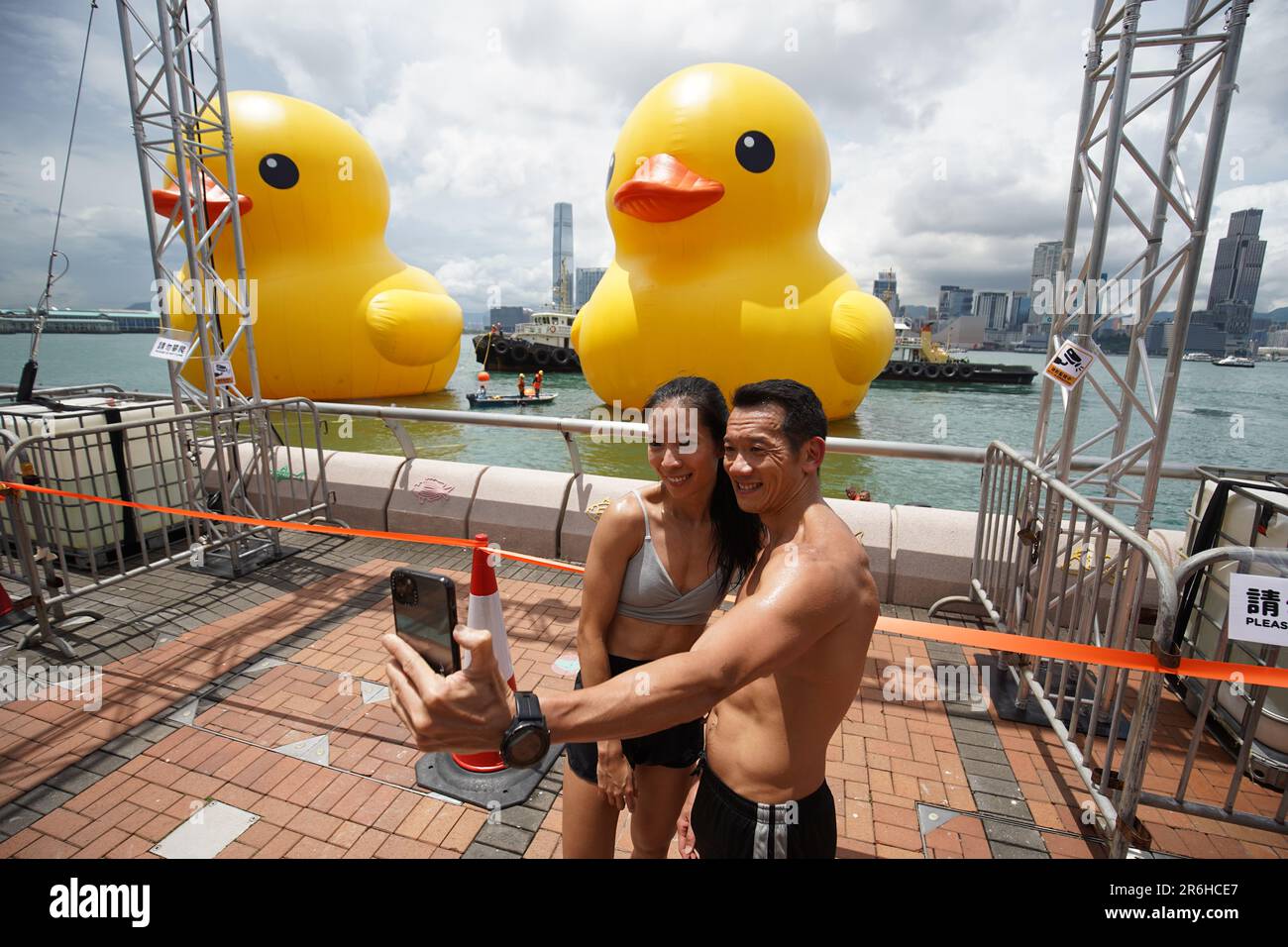 Hong Kong, Hong Kong. 09th June, 2023. People take selfies in front of two enormous inflatable ...