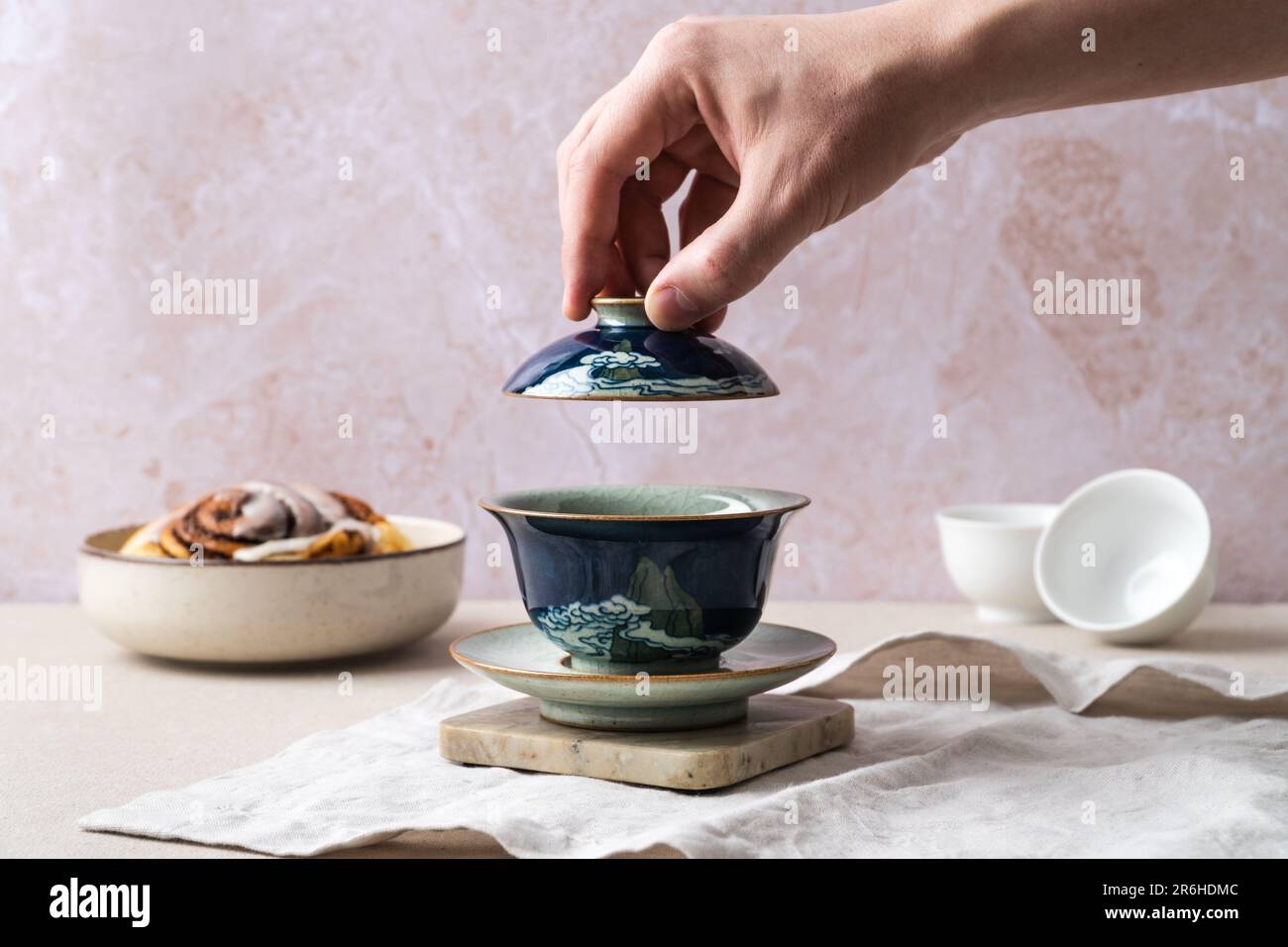 An adult hand grasping a delicate Hand-painted Chinese Gaiwan ...