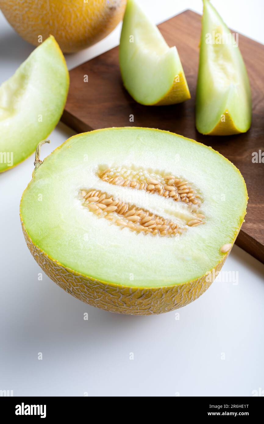 Half melon and sliced pieces of melon on white background Stock Photo ...