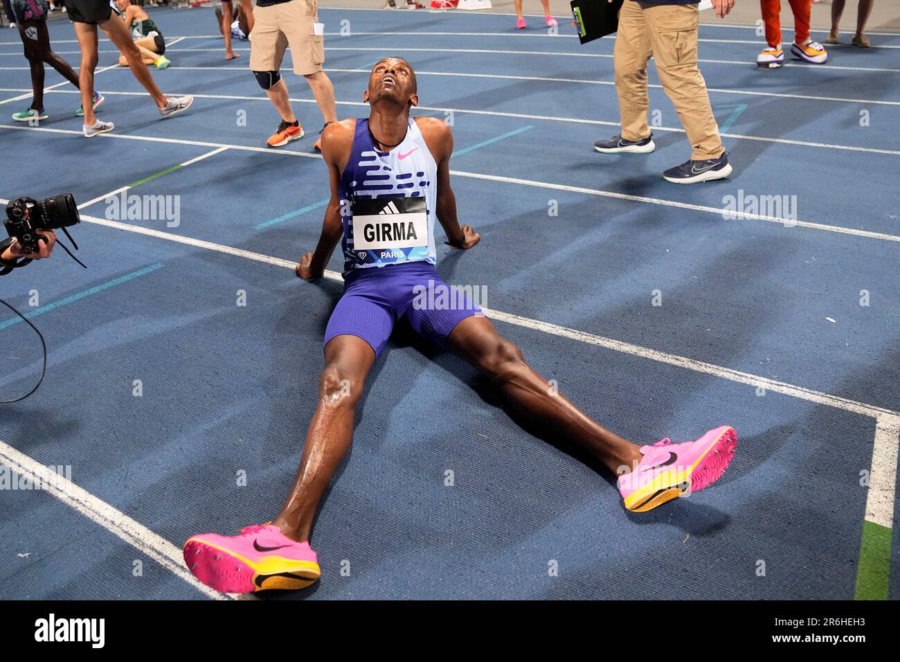 Lamecha Girma, of Ethiopia, sits down on the track after winning the ...