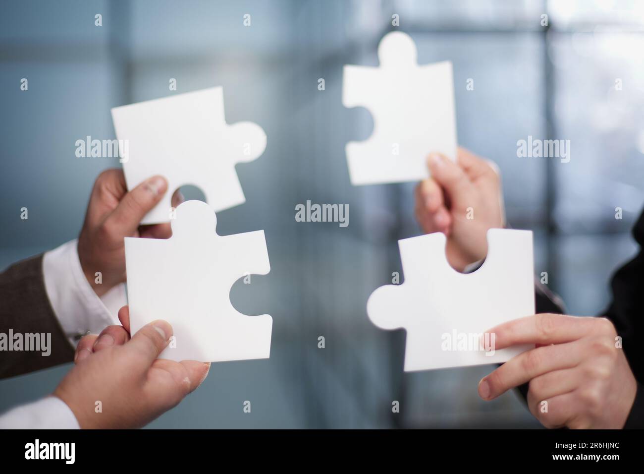 Working together to put things together. two unrecognizable ...