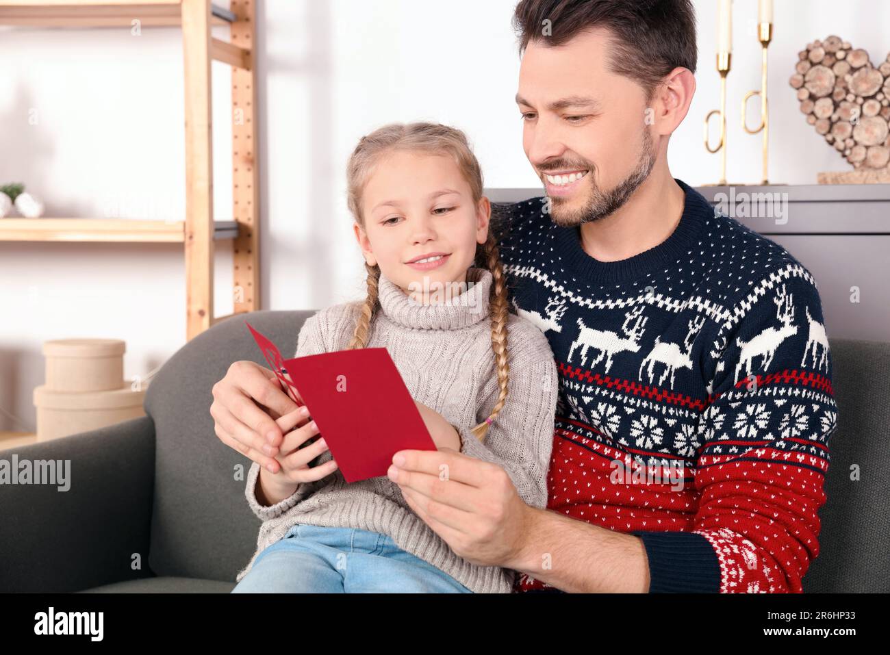 Happy man receiving greeting card from his daughter at home Stock Photo ...