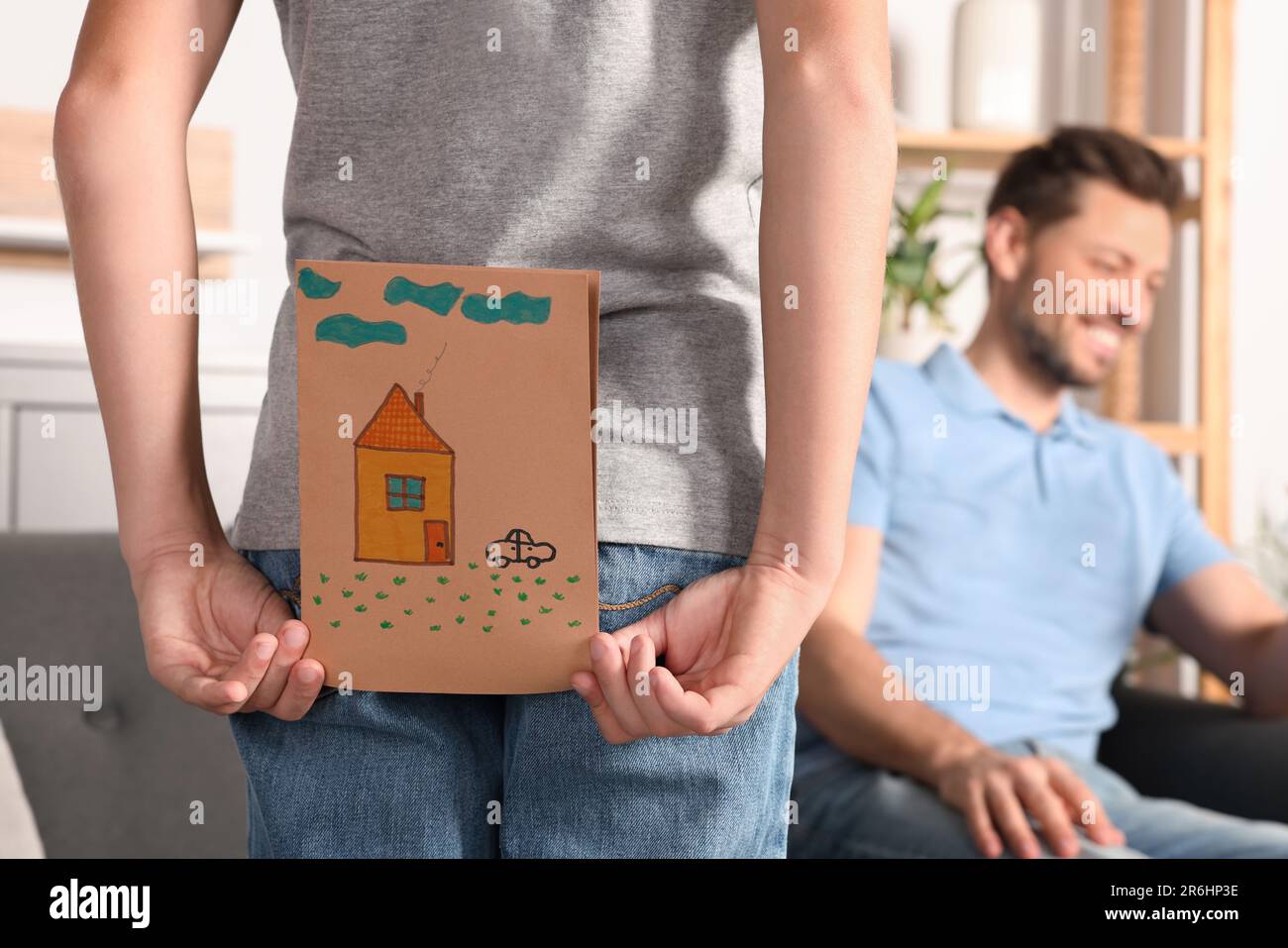 Boy hiding greeting card for his father behind back at home Stock Photo ...
