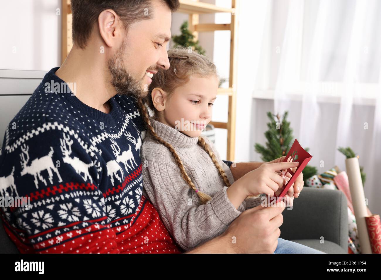 Happy man receiving greeting card from his daughter at home Stock Photo ...