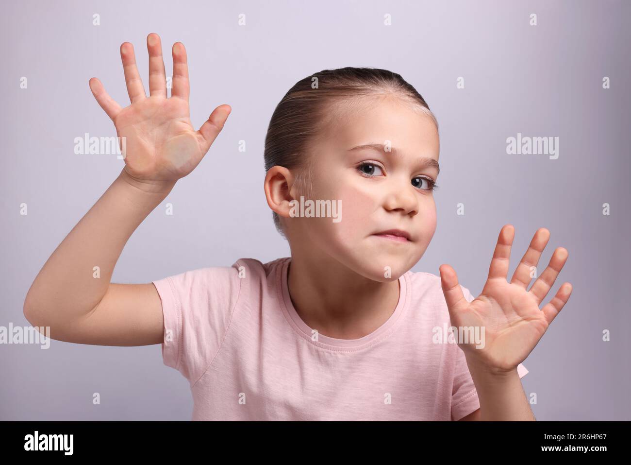 Cute little girl stuck to transparent screen Stock Photo - Alamy