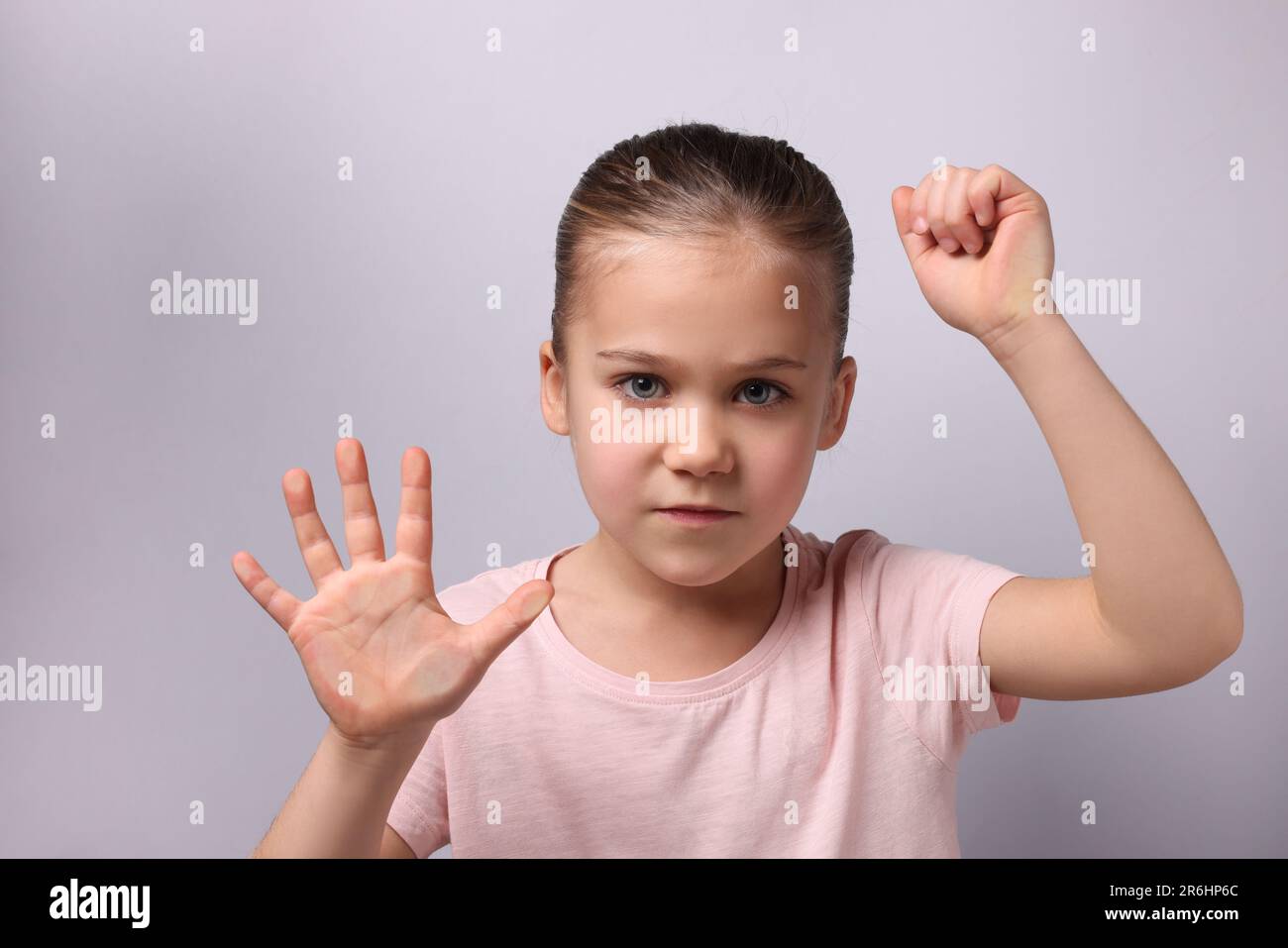 Cute little girl stuck to transparent screen Stock Photo - Alamy