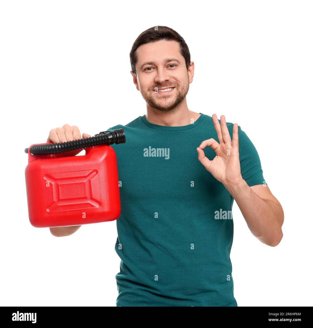 Man holding red canister and showing OK gesture on white background ...