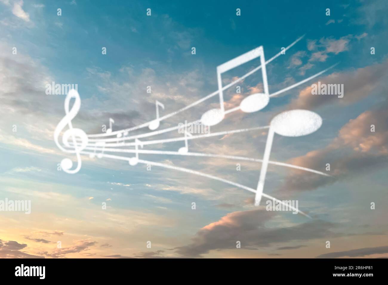 Staff with treble clef and musical notes against sunset sky Stock Photo ...