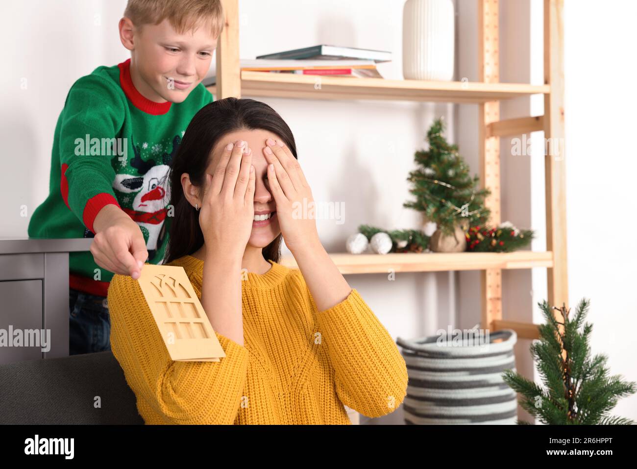 Happy woman receiving greeting card from her son at home Stock Photo ...