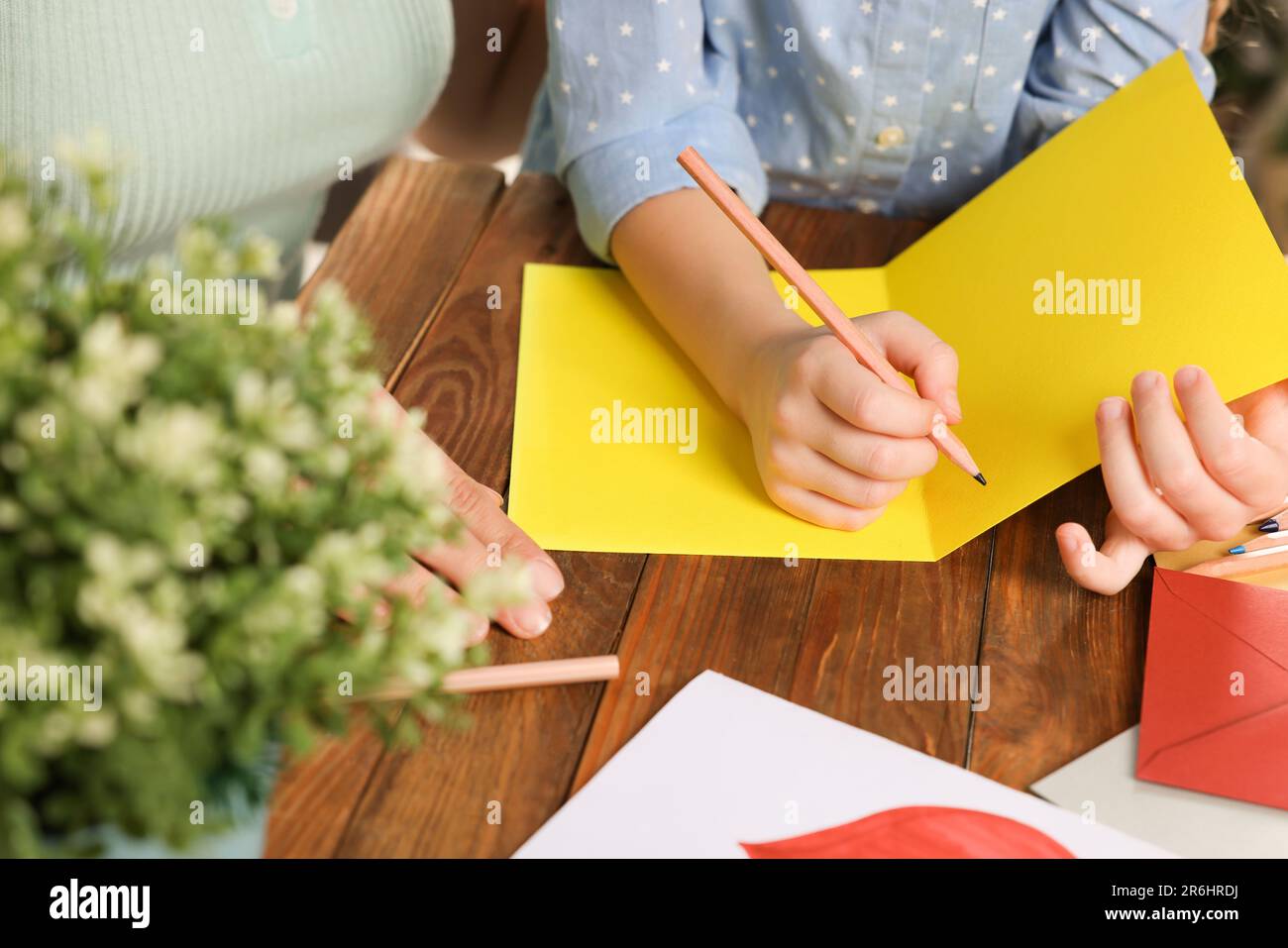 Little girl with her mother making beautiful greeting card at home ...