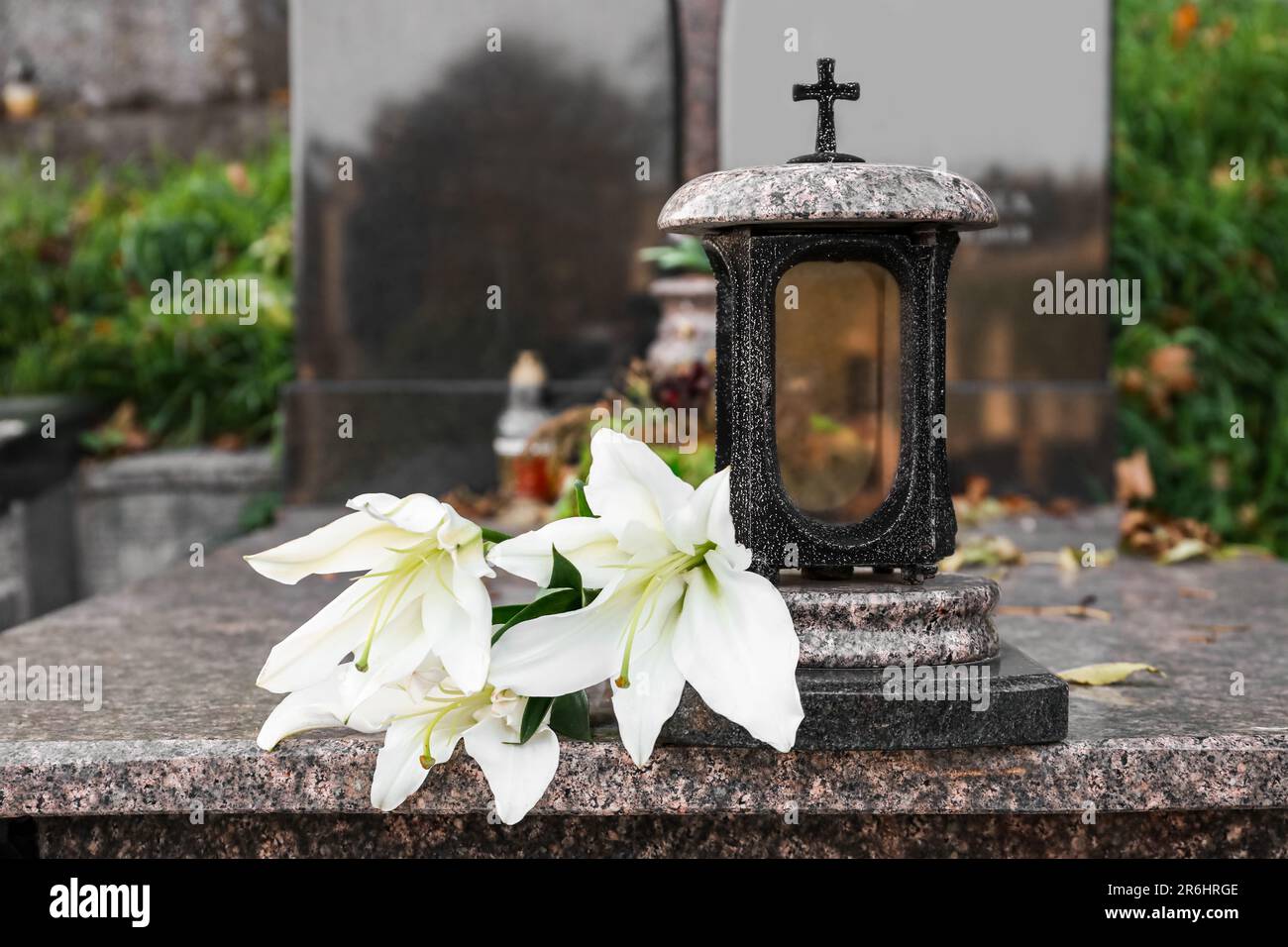 White lilies and grave light on granite tombstone outdoors. Funeral ceremony Stock Photo - Alamy