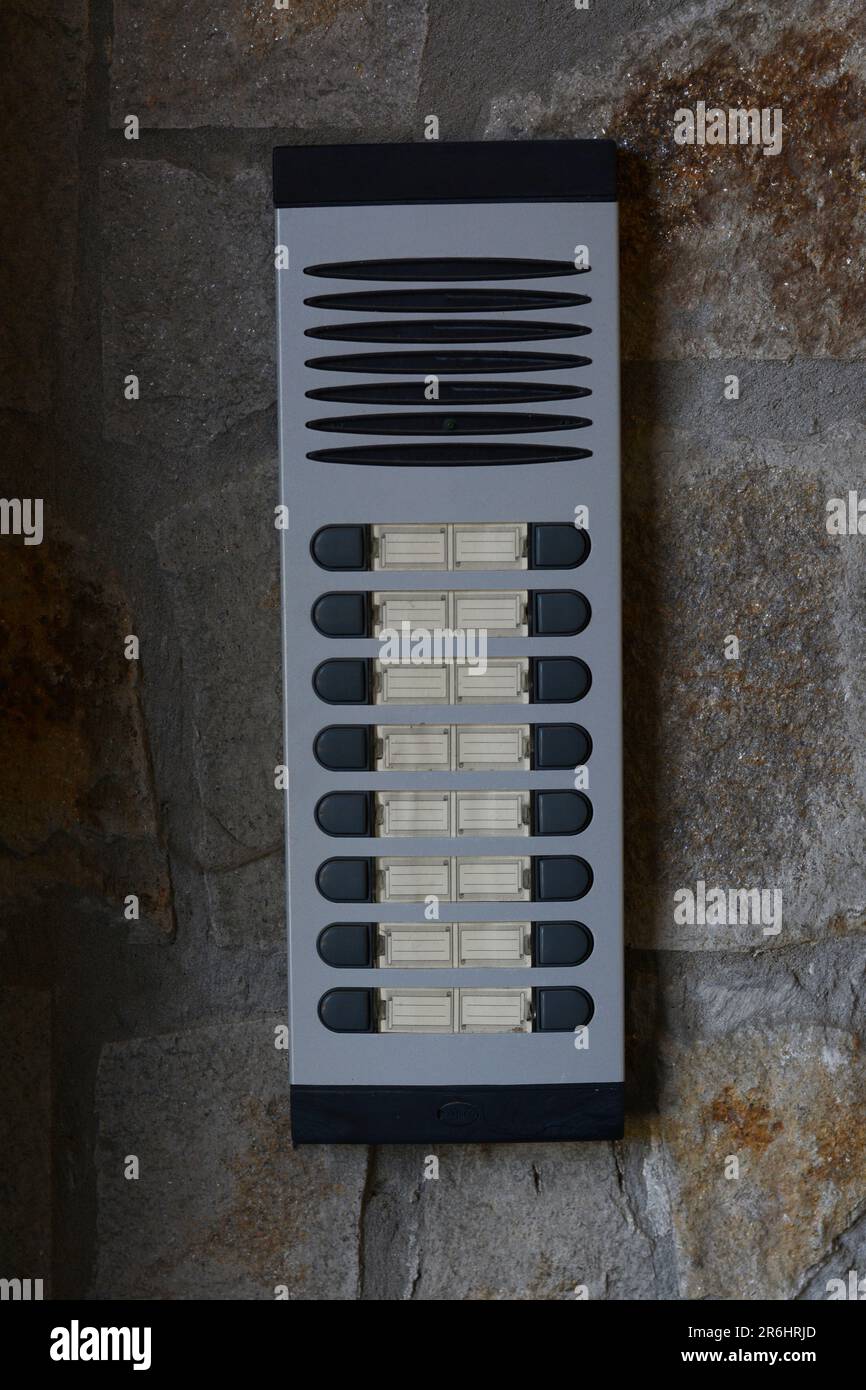 Modern intercom on concrete wall with stone fragments. Security system ...