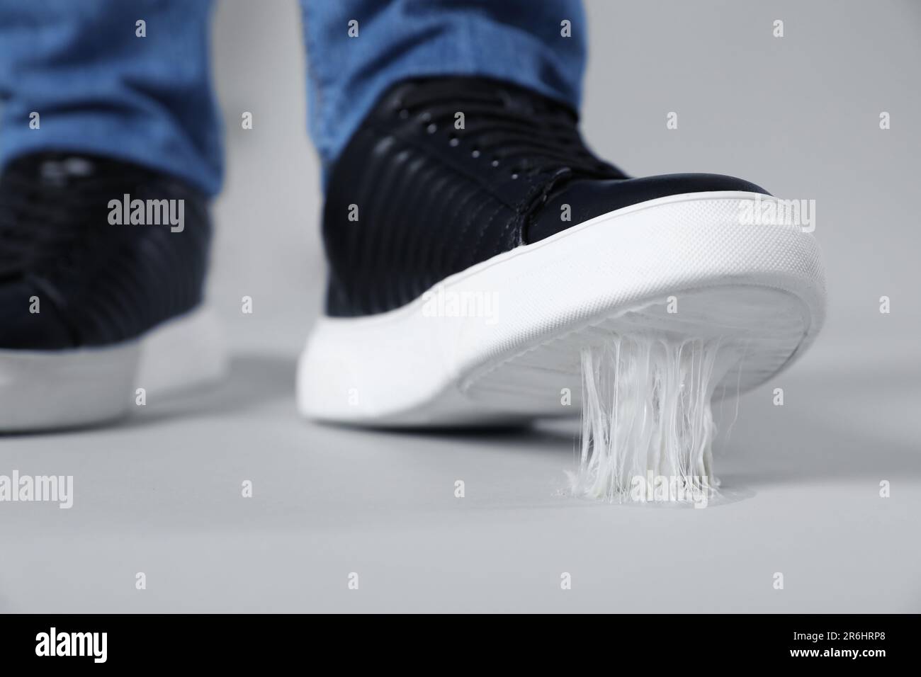 Man stepping into chewing gum on light grey background, closeup Stock ...