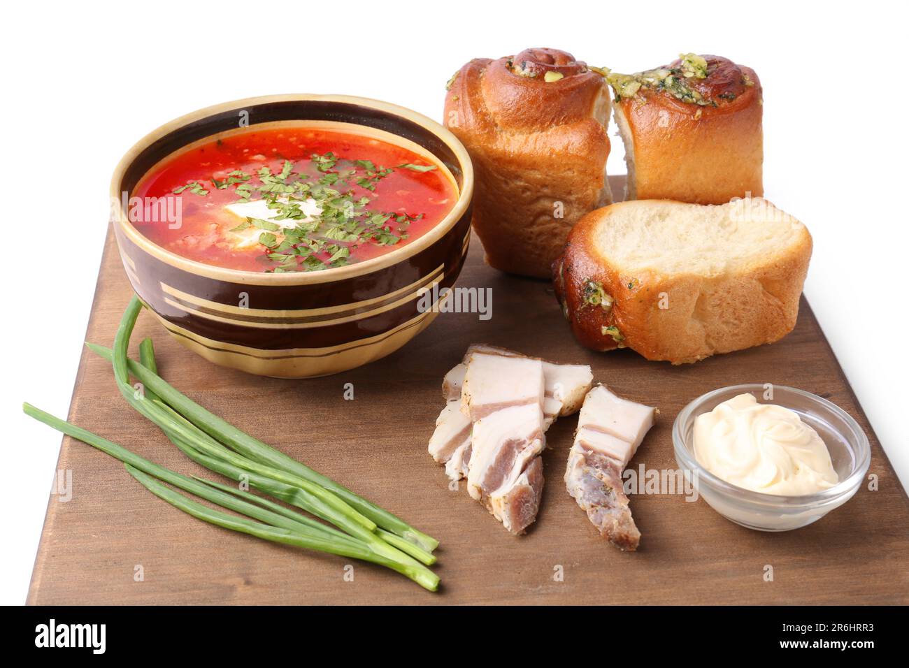 Delicious borsch served with pampushky, green onions and salo on white ...