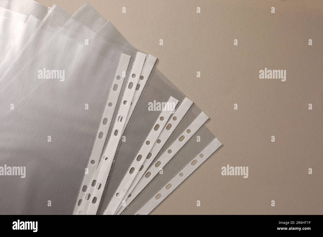 Punched pockets on light grey background, flat lay. Space for text ...