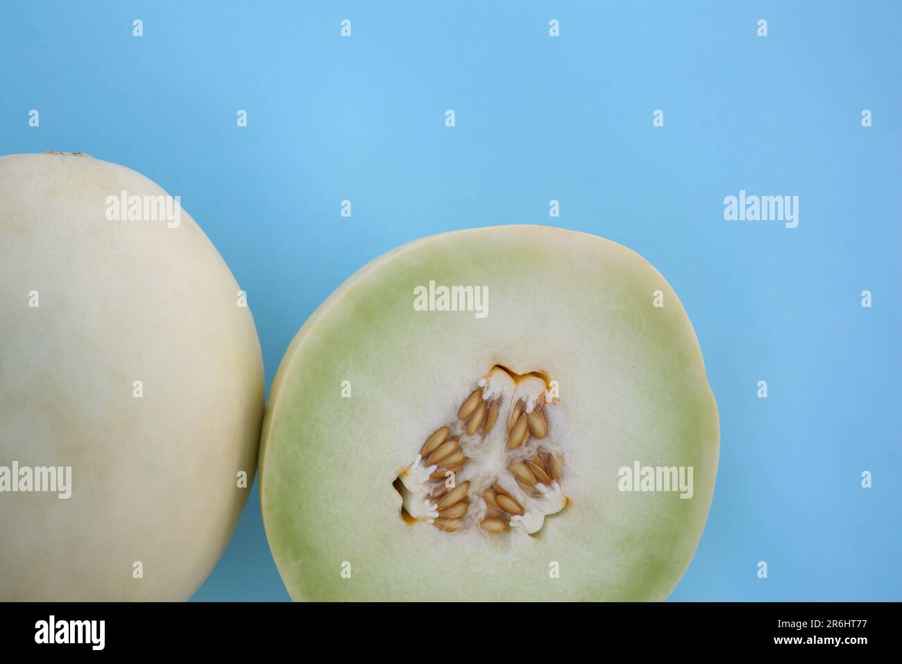 Whole and cut fresh ripe honeydew melons on light blue background, flat lay Stock Photo - Alamy