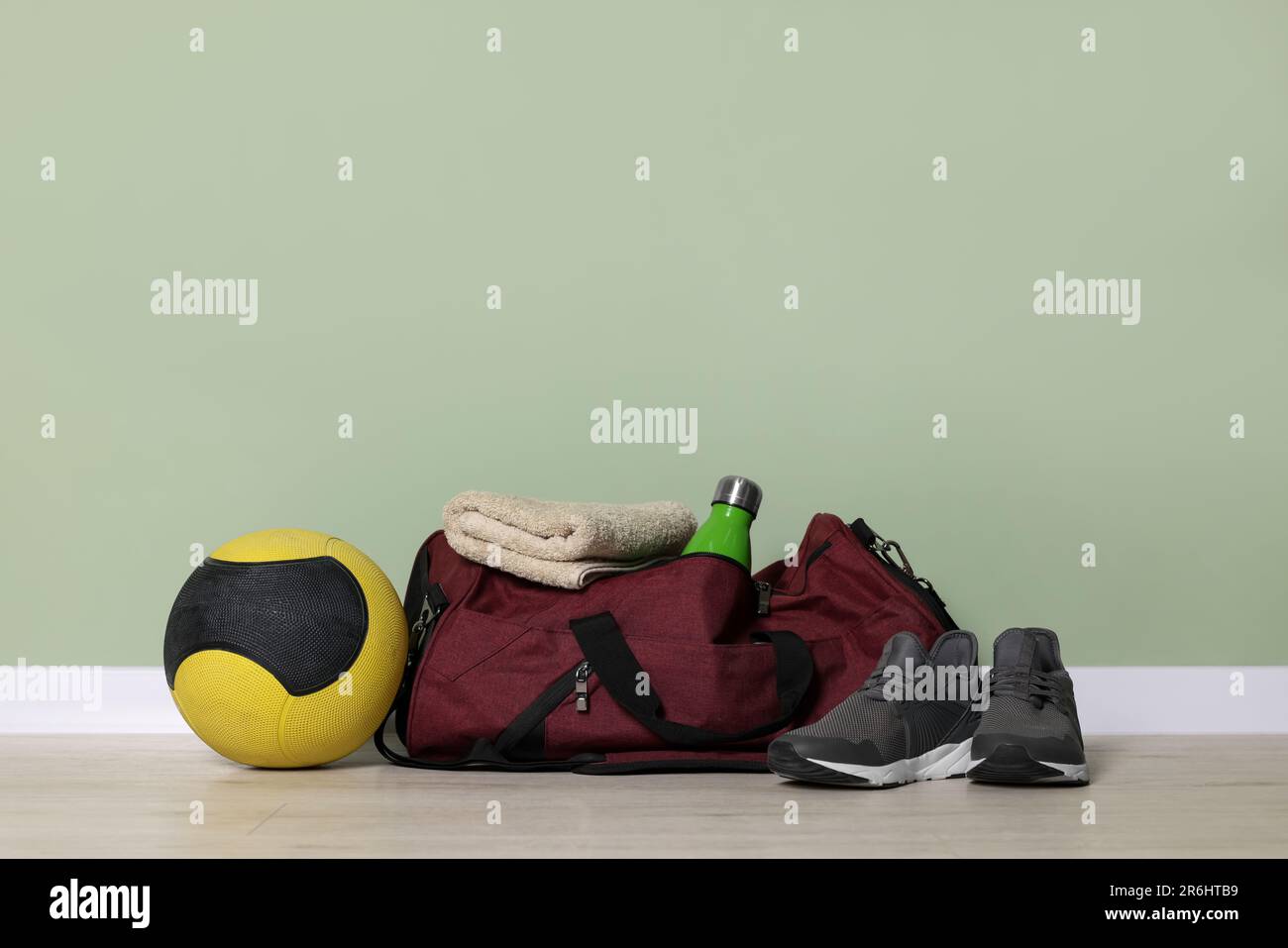 Gym bag and sports equipment on floor indoors Stock Photo - Alamy