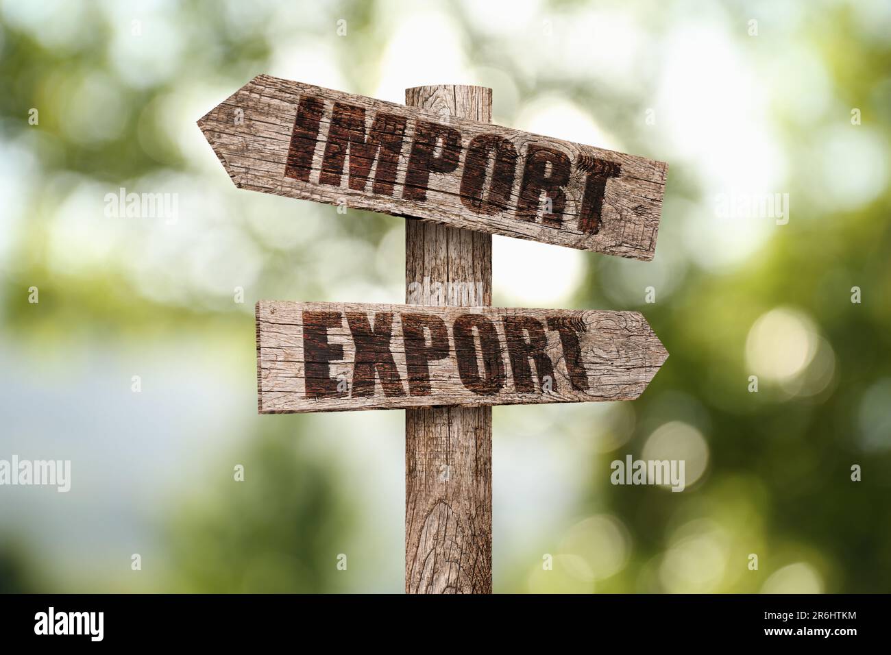 Wooden road sign with Import and Export words on arrows pointing in ...