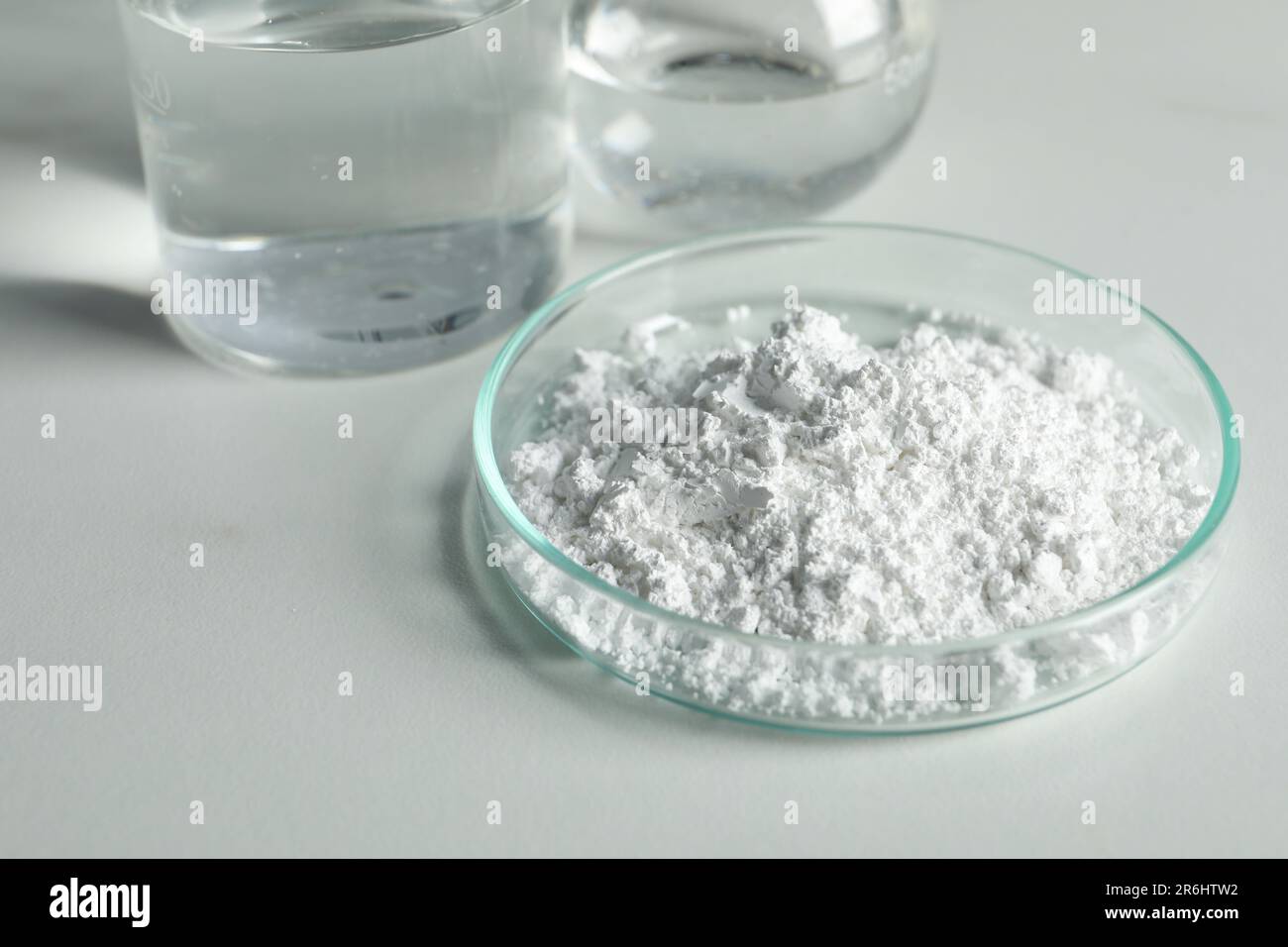 Petri dish with calcium carbonate powder and laboratory glassware on ...