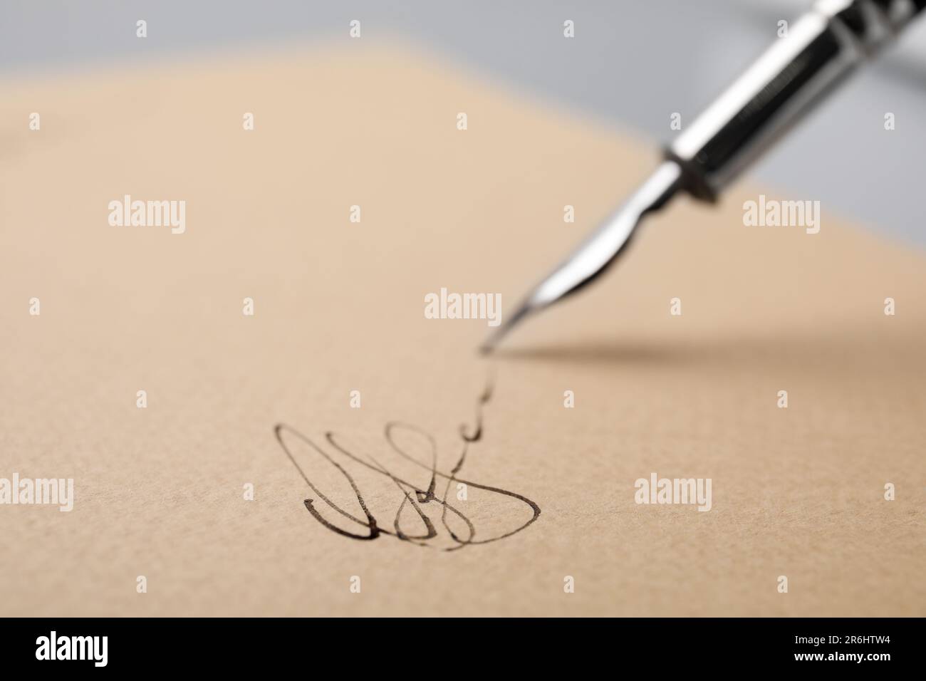 Signing on sheet of paper with fountain pen, closeup. Space for text ...