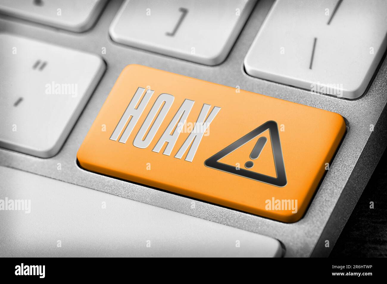 Orange button with word Hoax and warning sign on computer keyboard ...