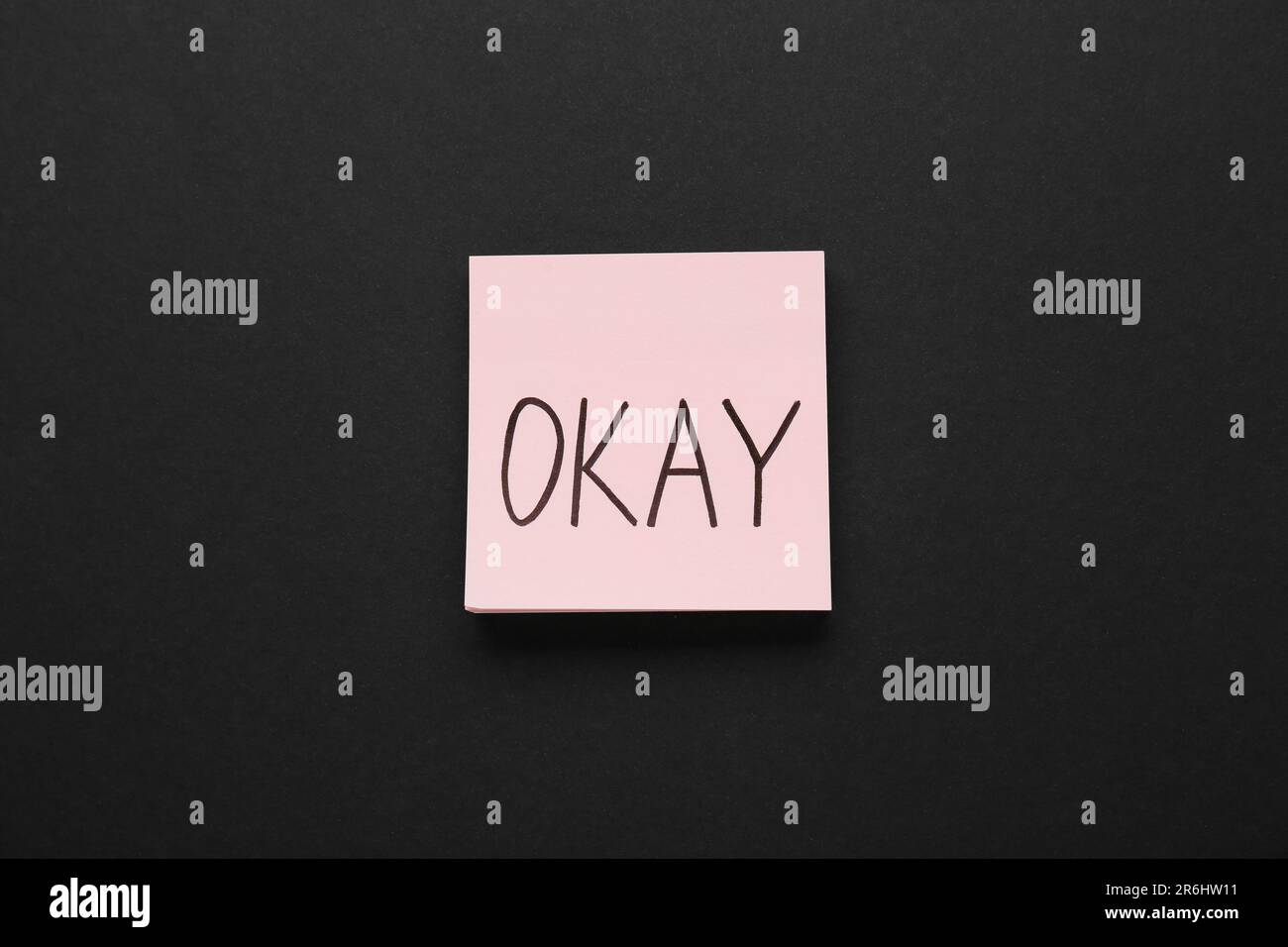 Note with word Okay on black background Stock Photo - Alamy