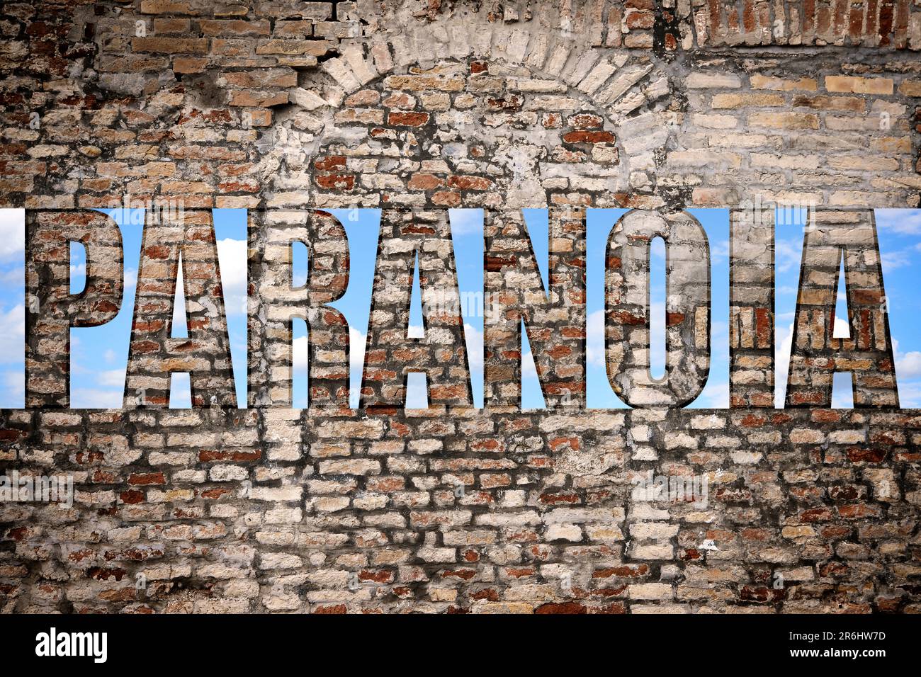 Mental disorder. View on blue sky through word Paranoia in brick wall ...