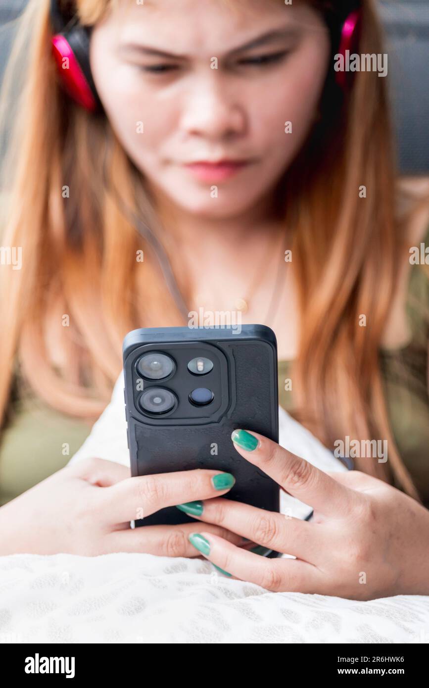 Sitting outside, on a high rise condo building balcony,wearing ...