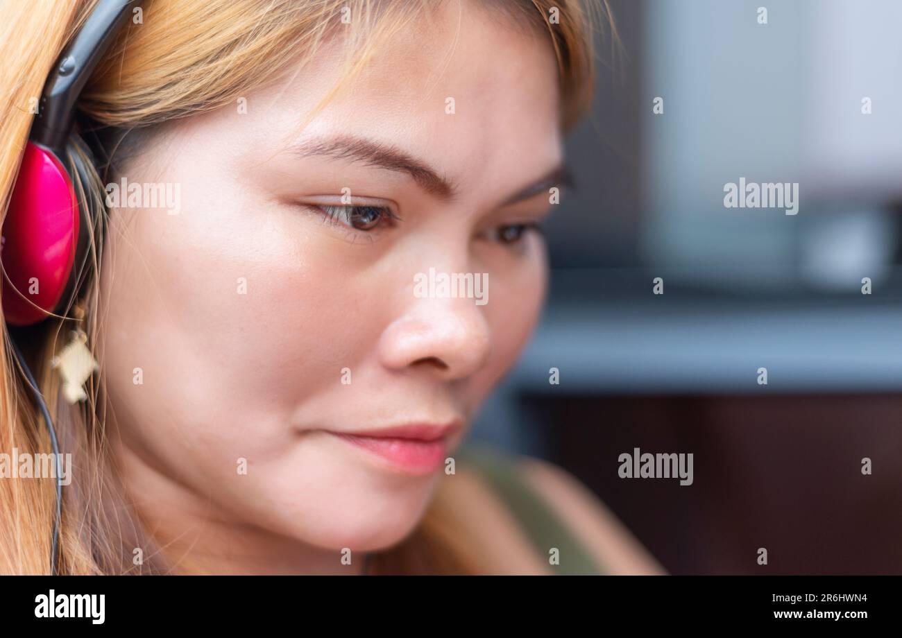 Sitting outside, on a modern high rise condo building balcony,wearing ...