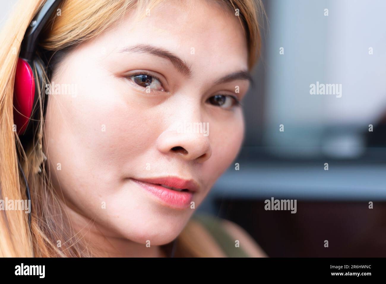 Sitting outside, on a modern high rise condo building balcony,wearing ...