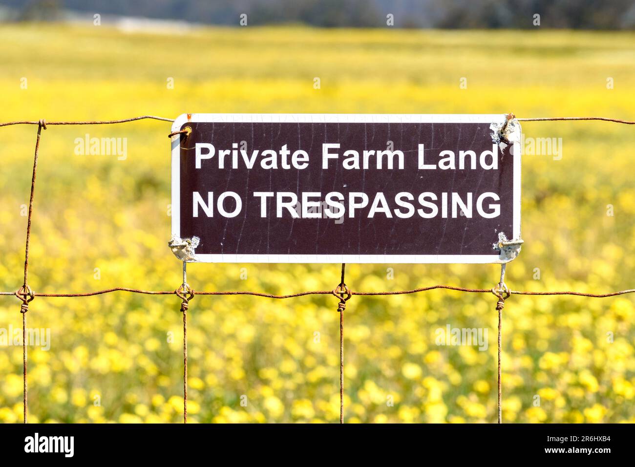 Private Farm Land No Trespassing sign posted on a barbed wire fence ...