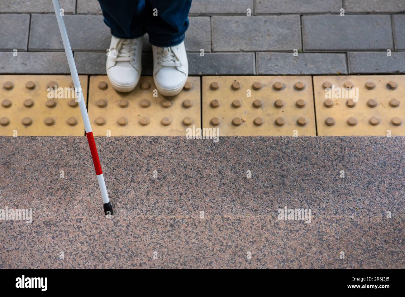 Blind woman walking outdoors using a tactile cane Stock Photo - Alamy