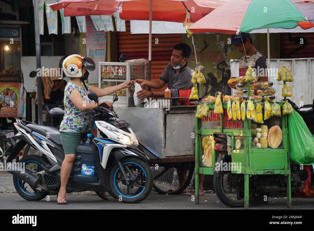 The seller of manisan. Candied golden apple fruit (manisan kedondong ...