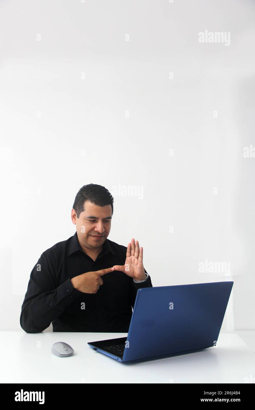 Latino adult man speaks Mexican sign language with a deaf person ...