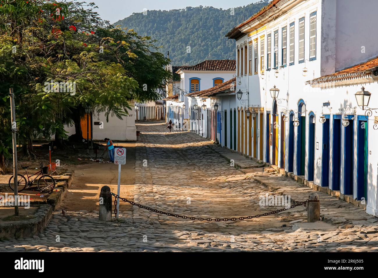 Typical cobblestone street with colonial buildings at a square with ...