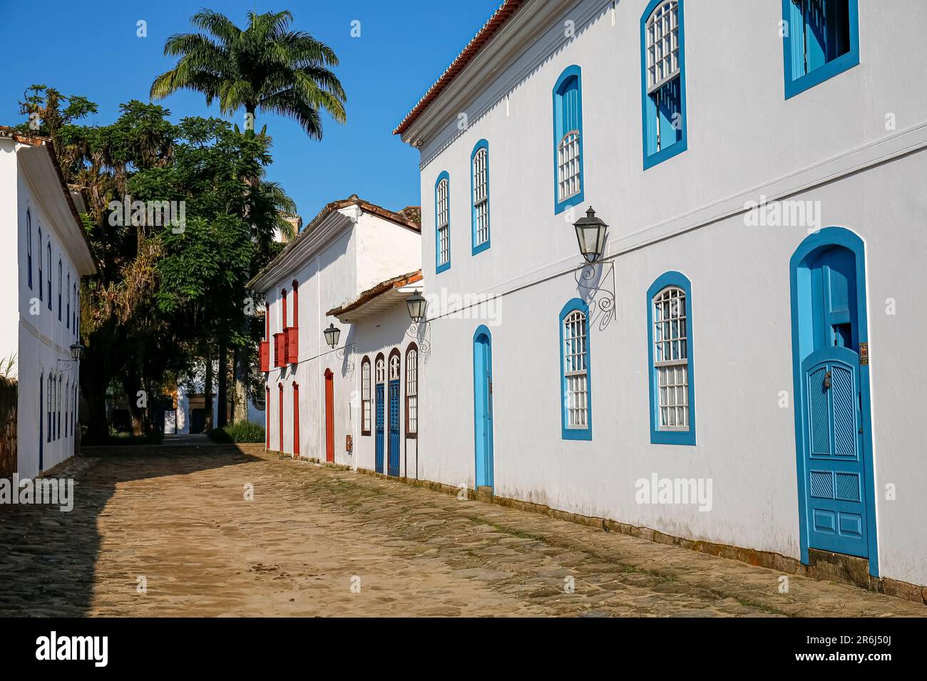 Typical cobblestone street covered with mud from high tide with ...