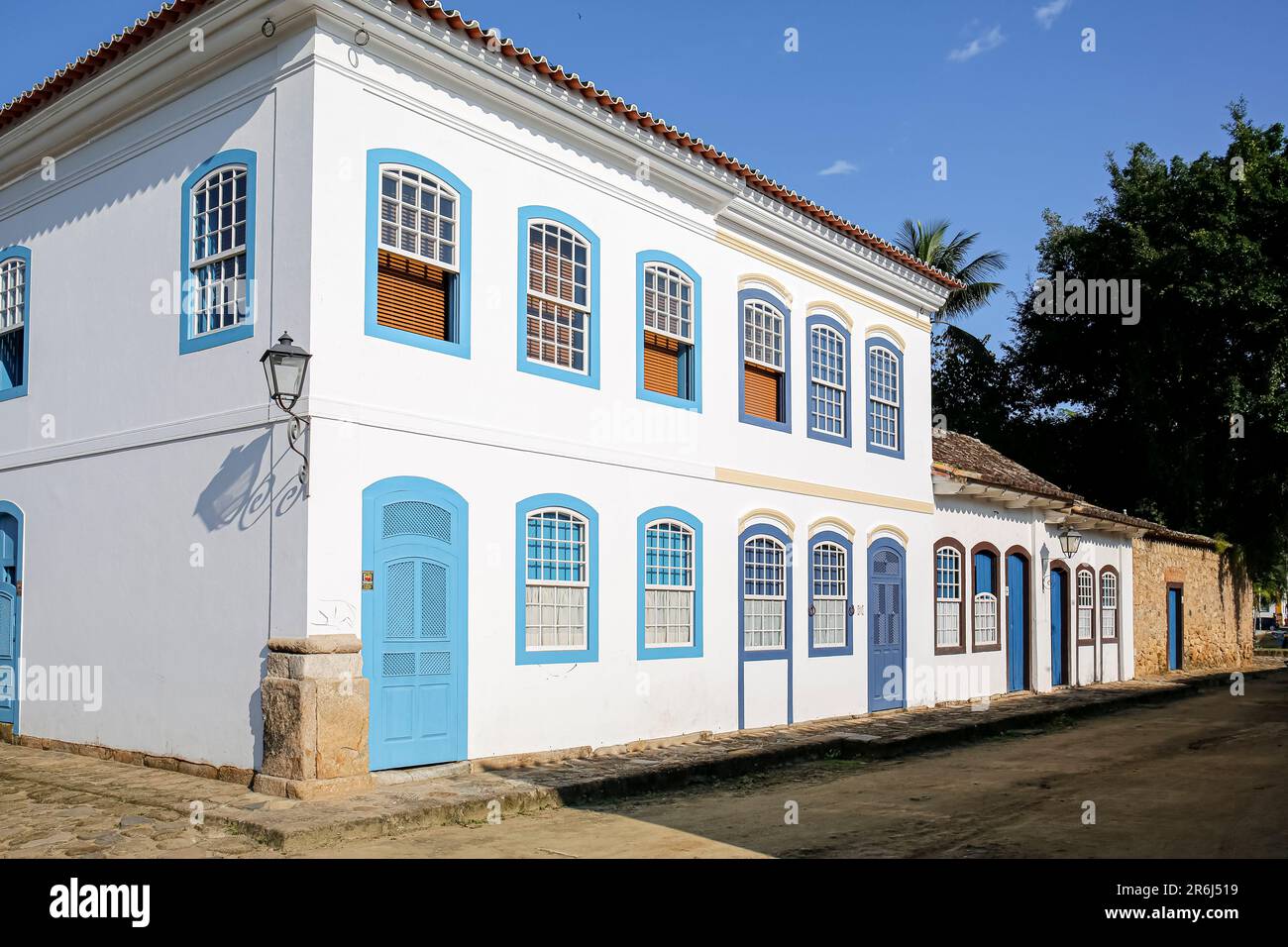 Corner two story and one story colonial houses n the late afternoon sun ...