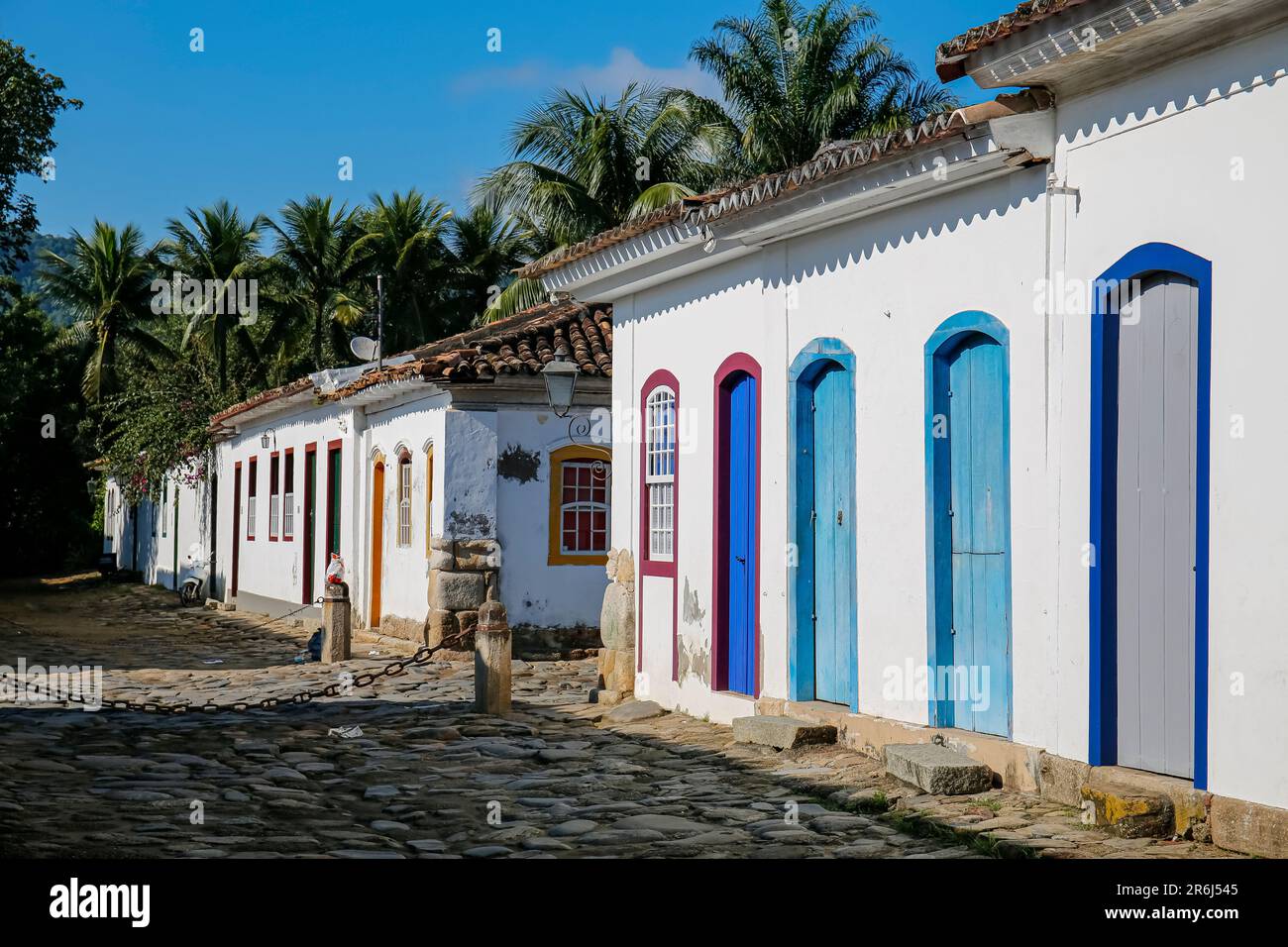 Typical house facades in sunshine with colorful doors and windows, in ...