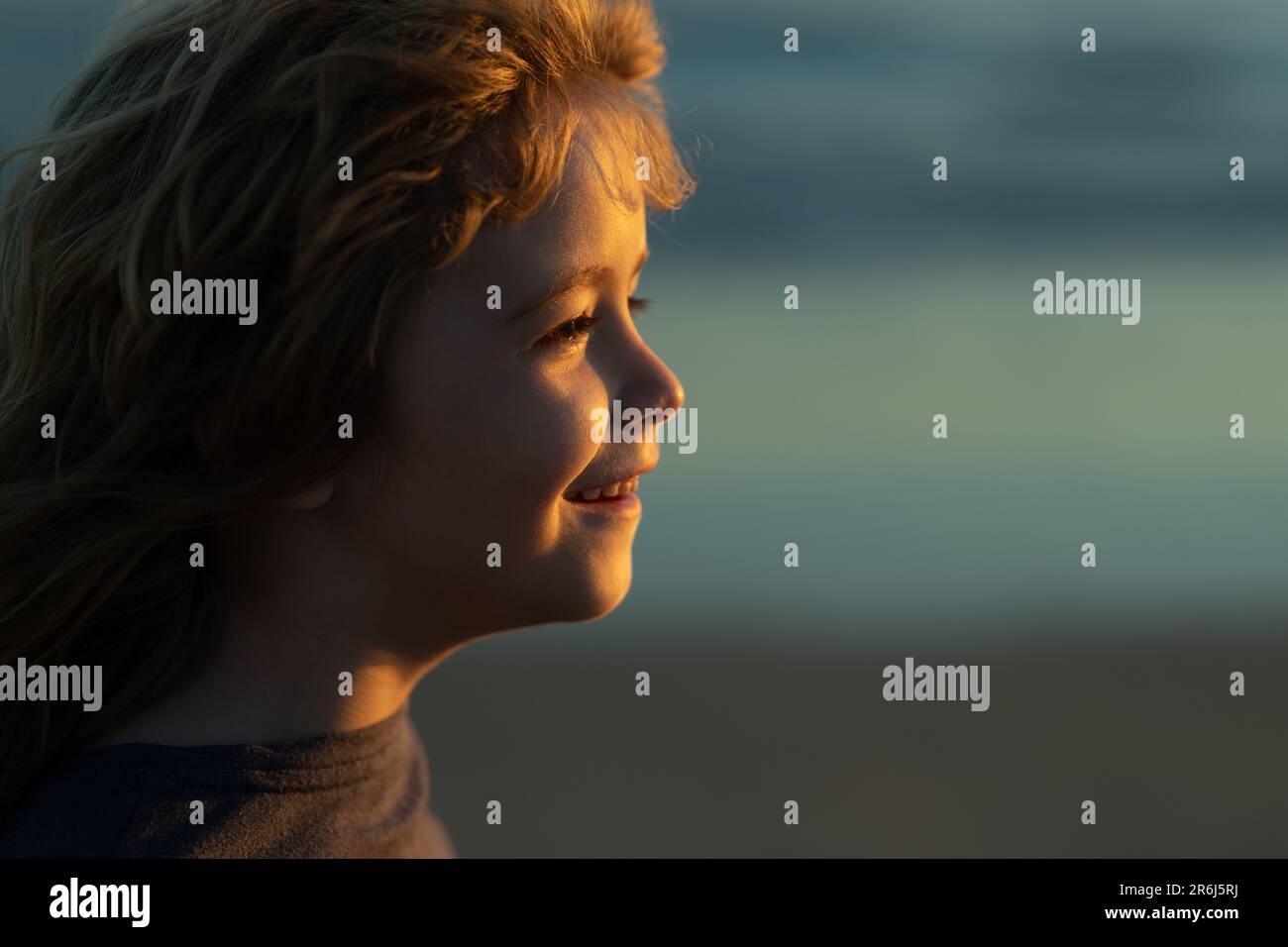 Kids dreaming face. Portrait of kid in spring park outdoors. Close-up ...