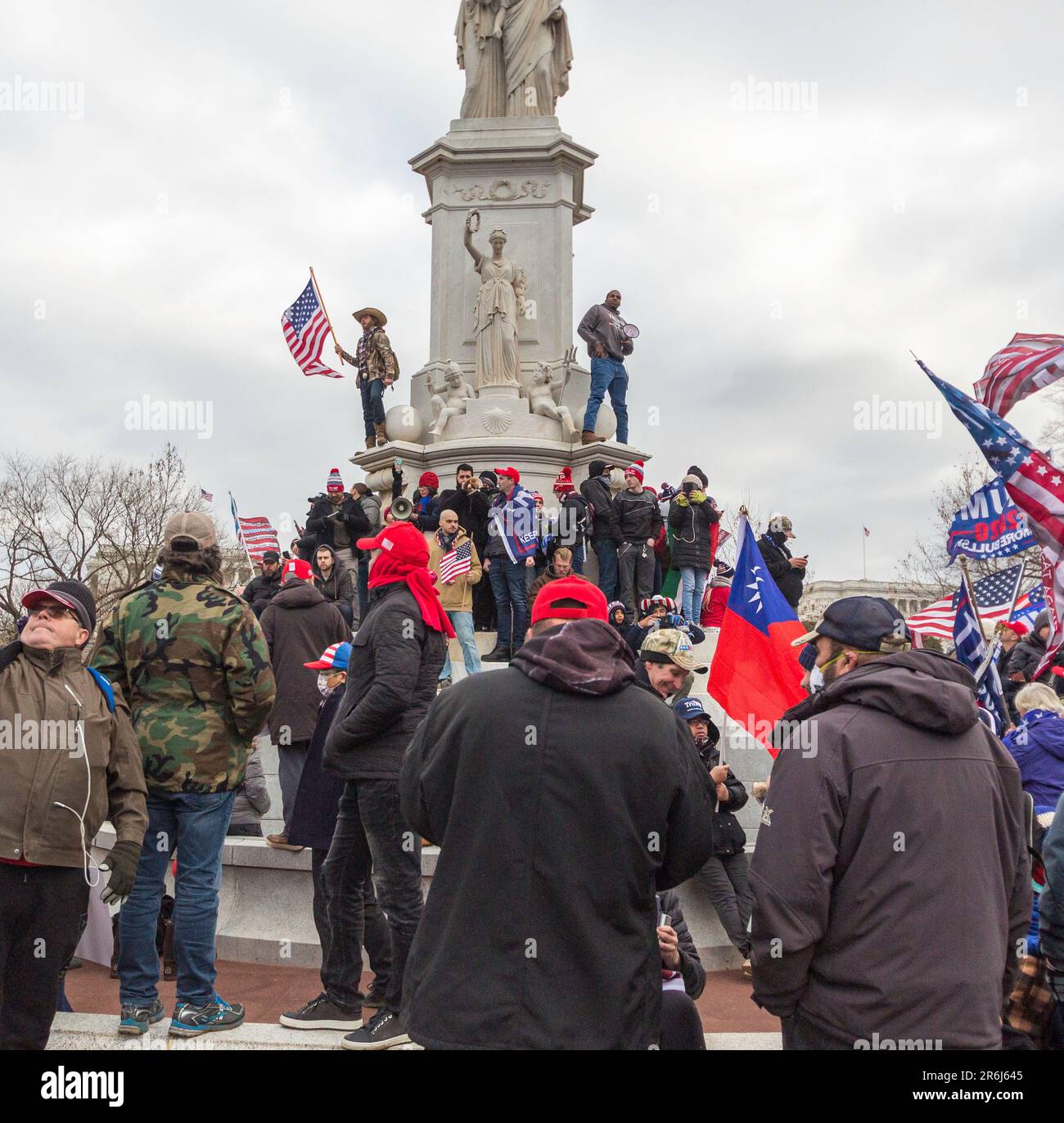 Rioters standing at the Peace monument during the January sixth protest ...