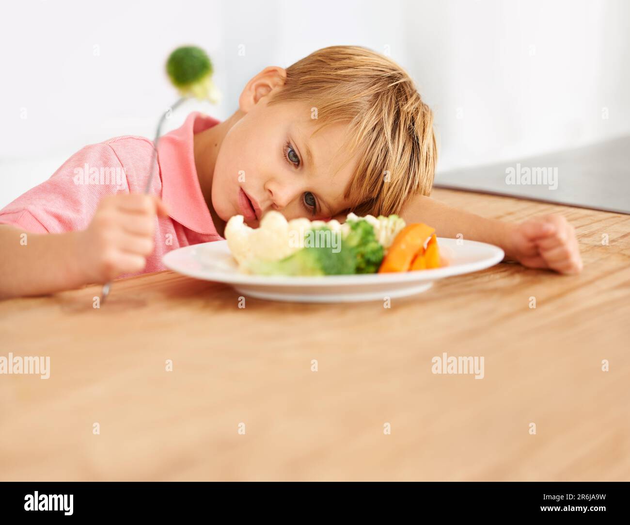 Sad, hungry and a child with vegetables for dinner, unhappy and problem ...
