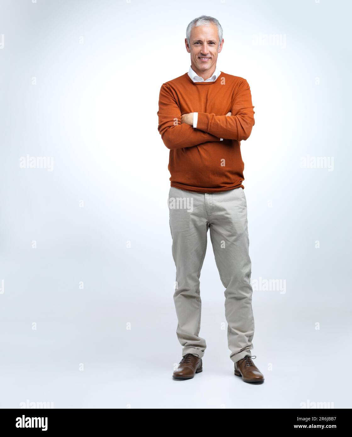 Mature man, portrait and arms crossed in a studio with modern style ...