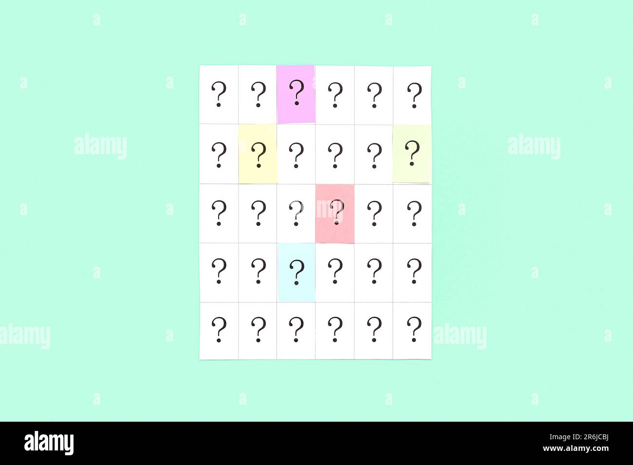 Paper with question marks on green background Stock Photo - Alamy