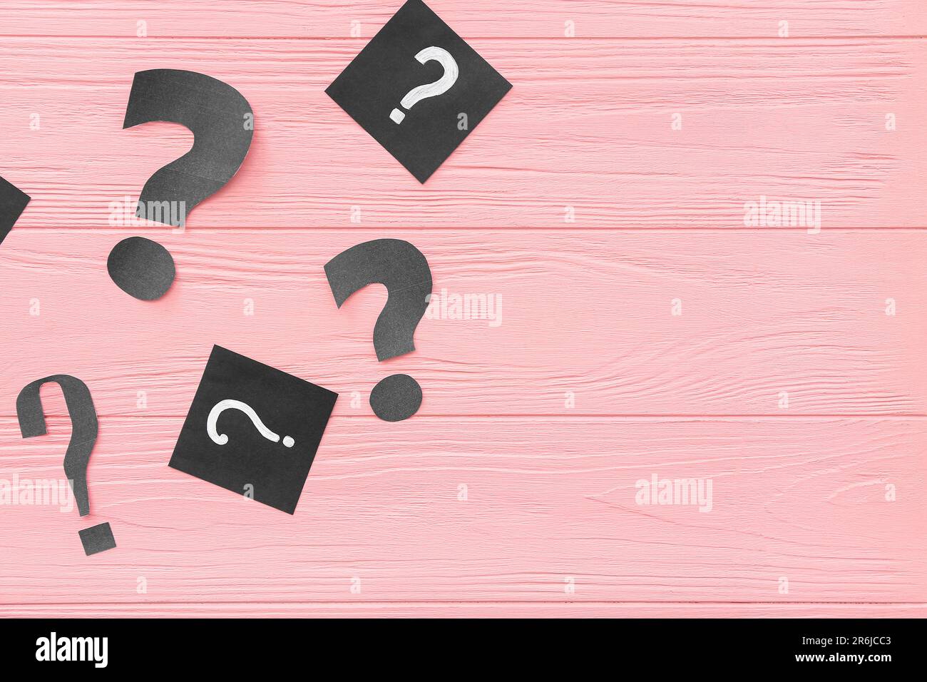 Paper question marks on pink wooden background Stock Photo - Alamy