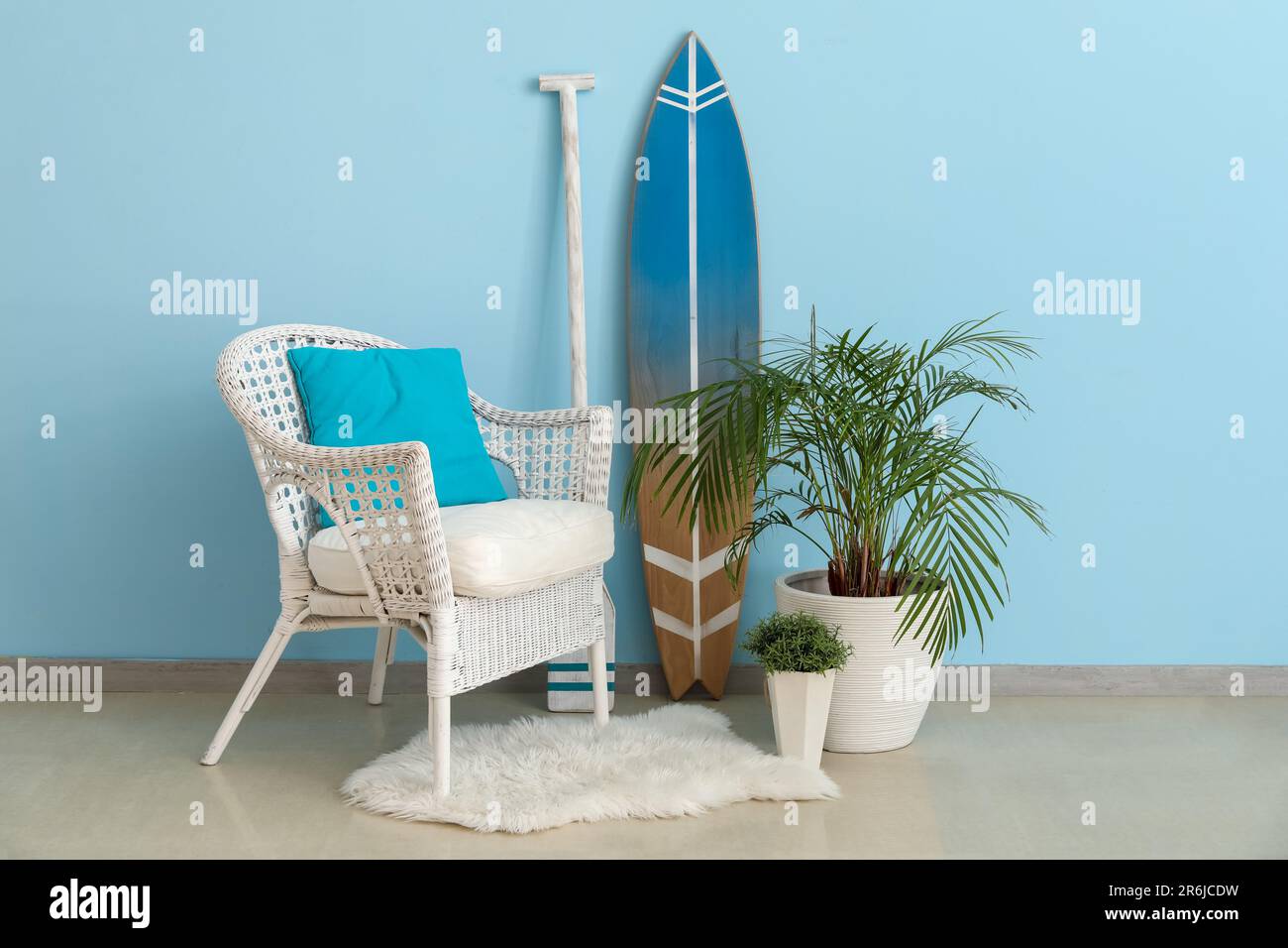 Interior of living room with surfboard, paddle and armchair Stock Photo ...